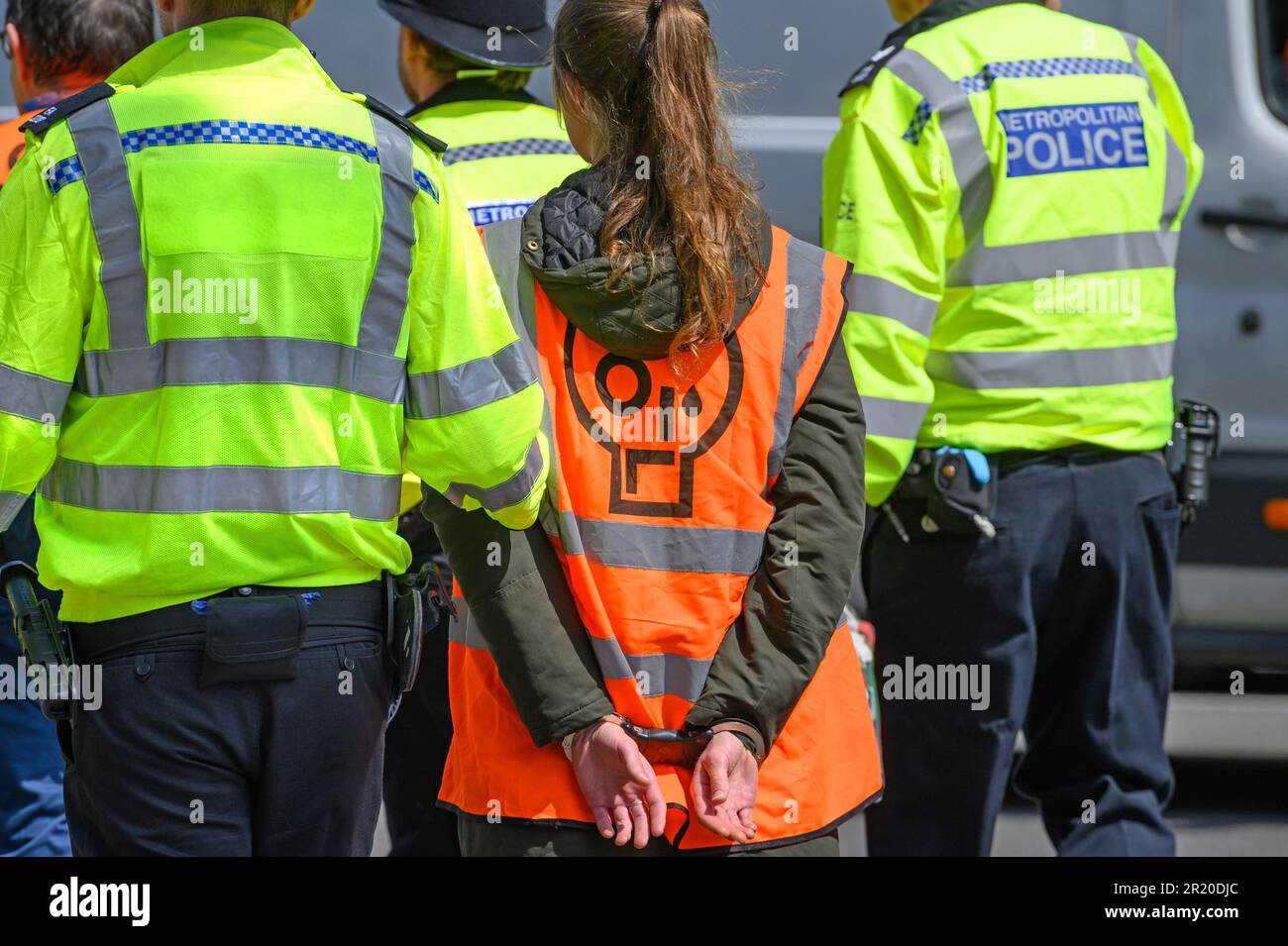 Young woman arrested in rigid handcuffs during a Just Stop Oil protest ... Young woman arrested in rigid handcuffs during a Just Stop Oil protest ...