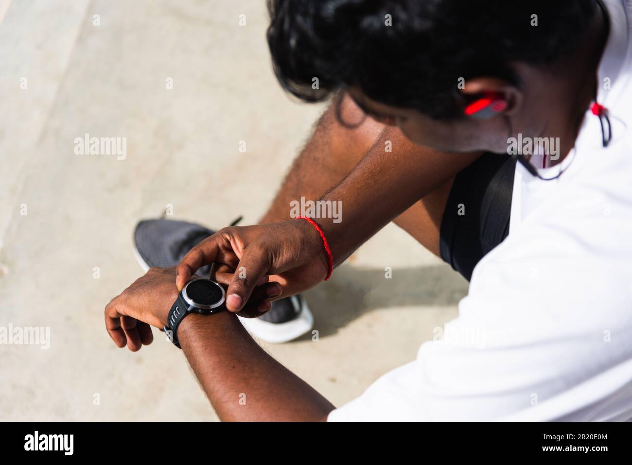 sport runner black man wear modern time smart watch he sitting resting ...