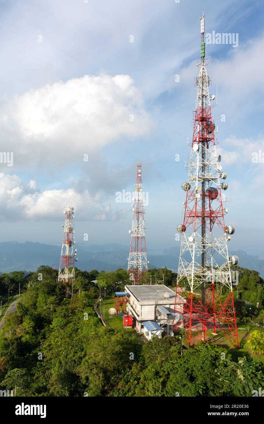 telecommunication towers with antennas with beautiful blue sky background on mount gunung raya ...