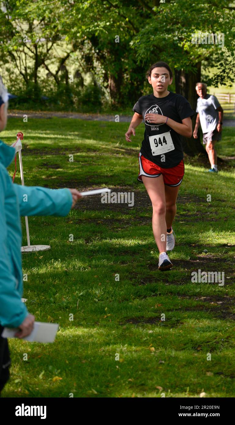Participants cross the finish line after completing a 5K race in ...