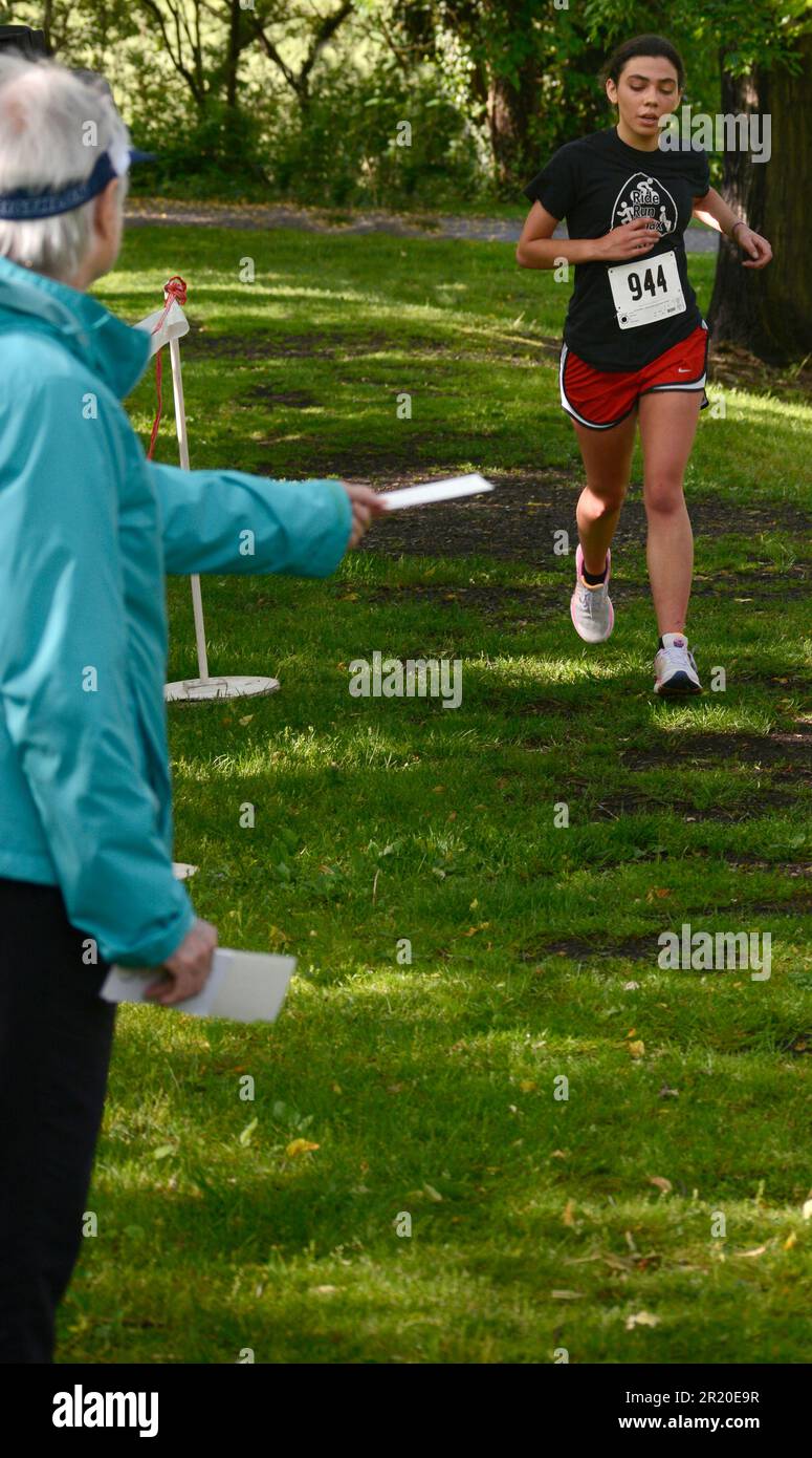 Participants cross the finish line after completing a 5K race in ...