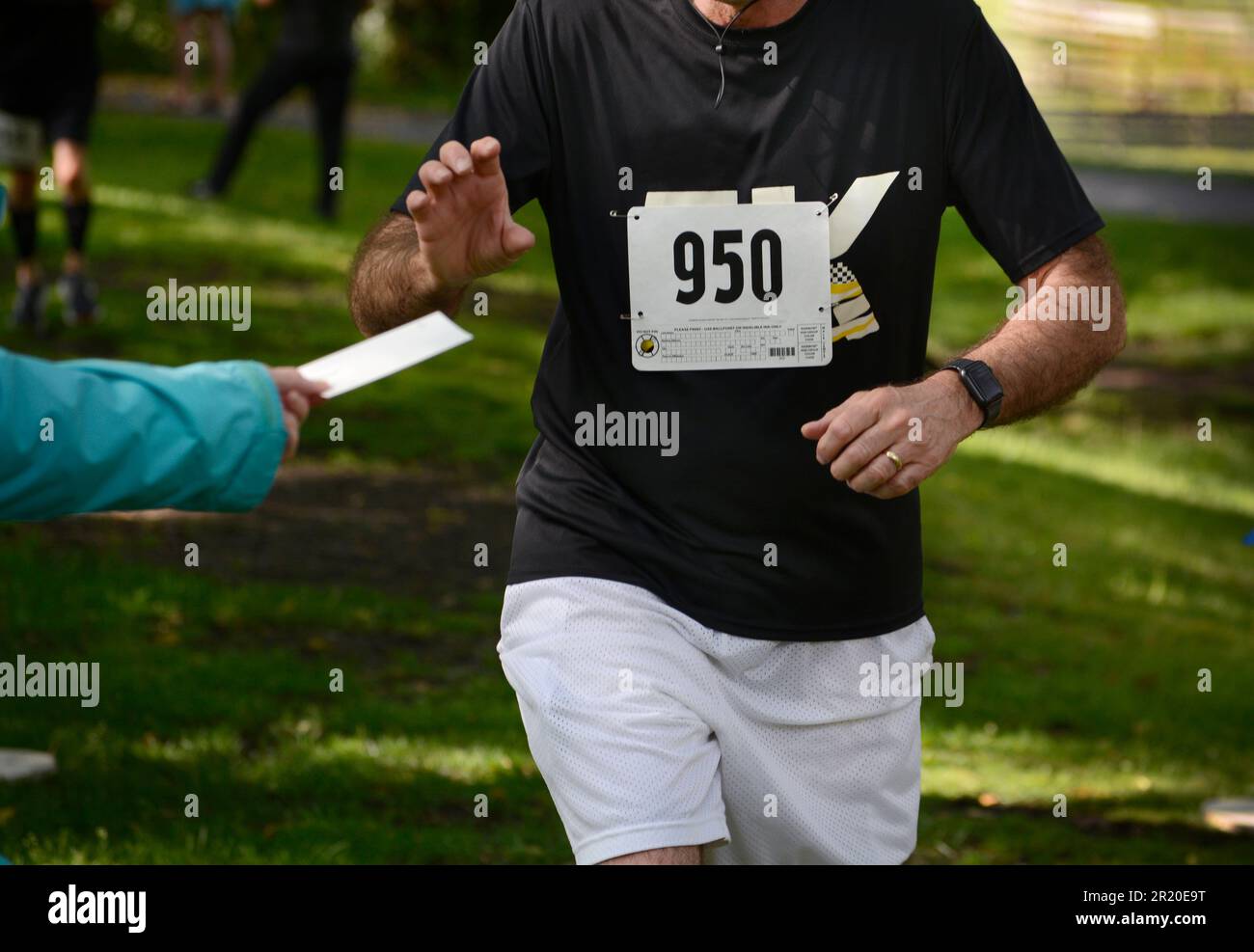 Participants cross the finish line after completing a 5K race in ...