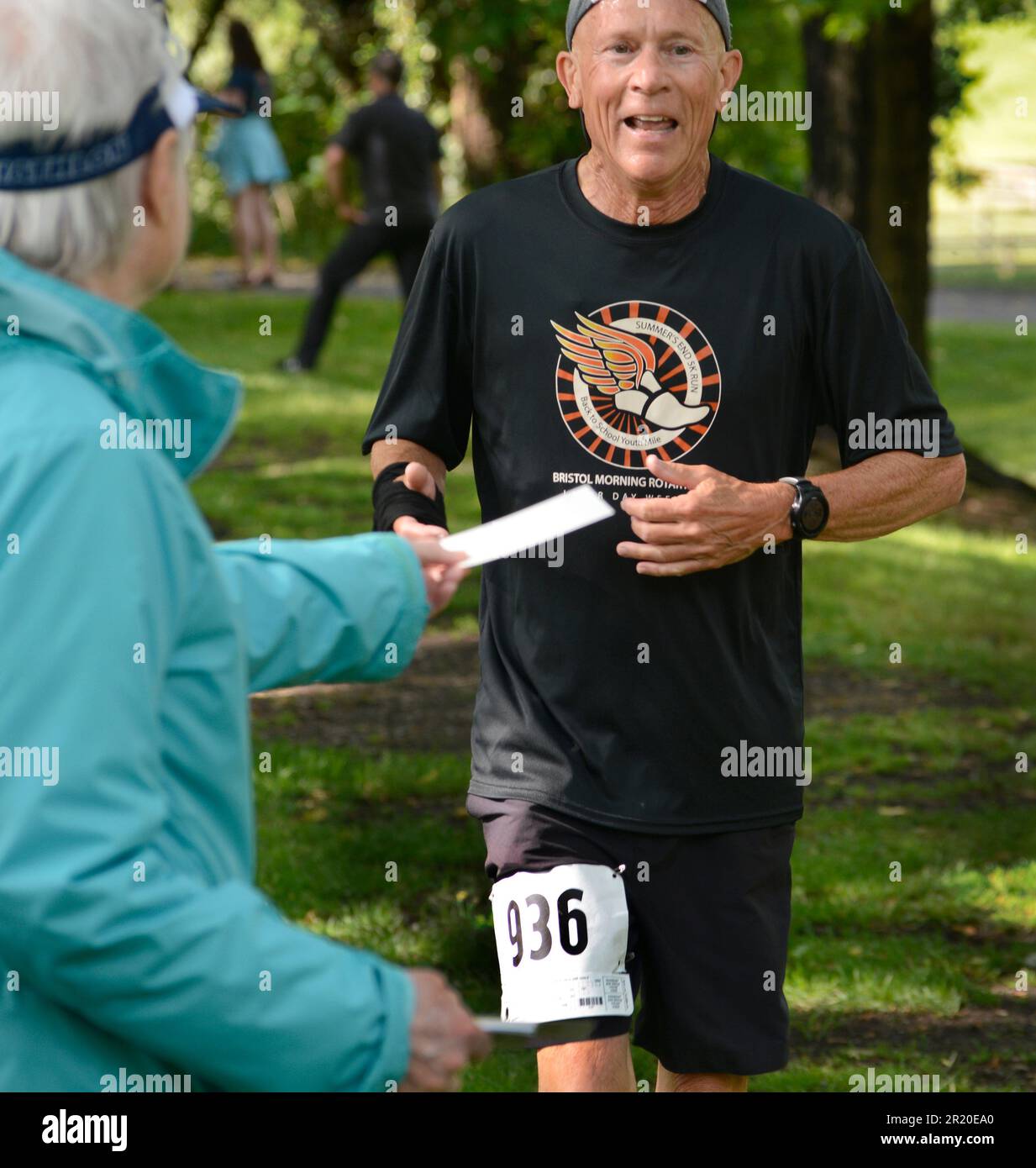 Participants cross the finish line after completing a 5K race in ...