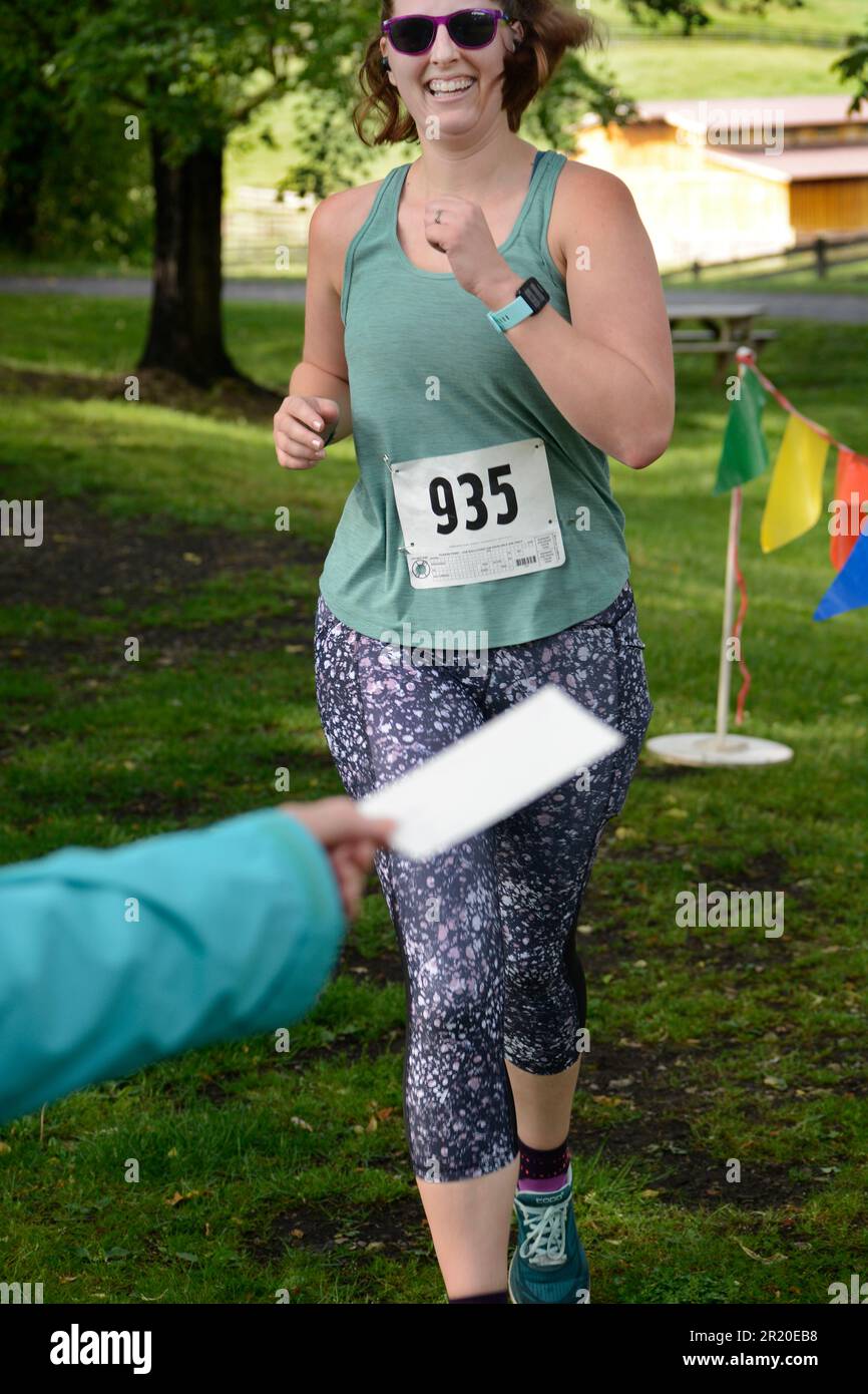 Participants cross the finish line after completing a 5K race in ...