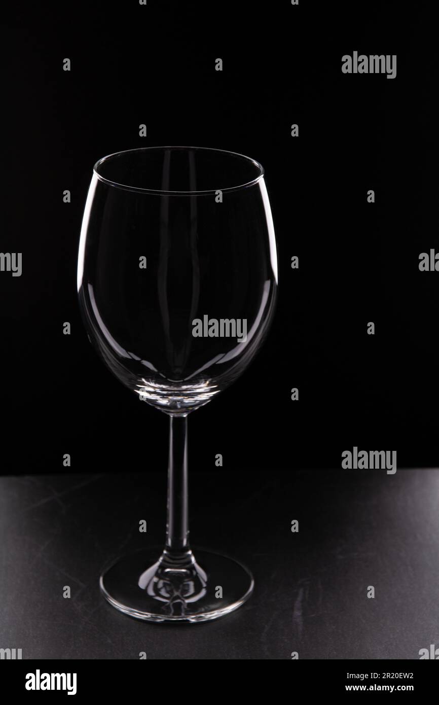 photo glass for alcohol on a black background on the table Stock Photo ...