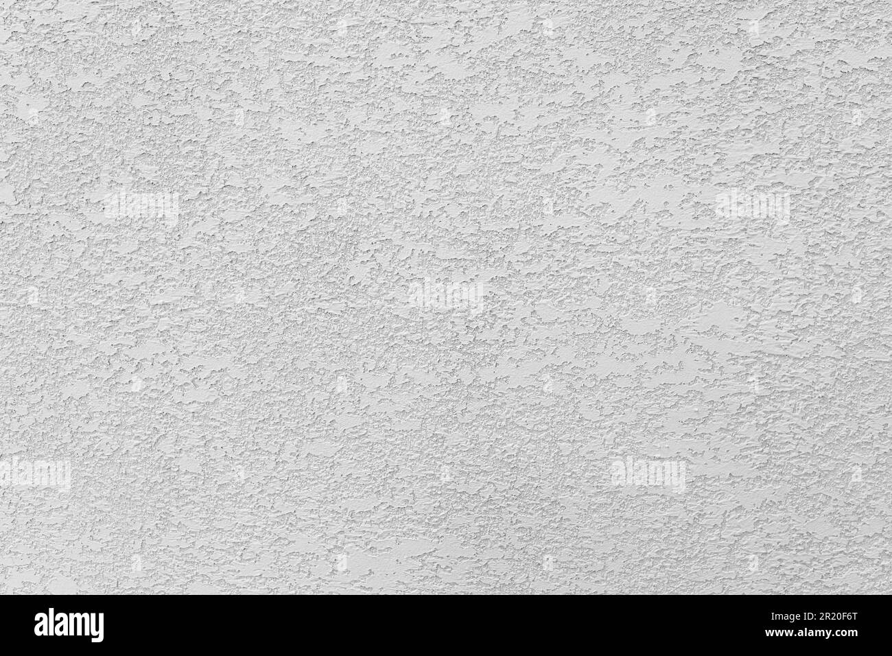 White-gray uniform background of decorative textured plaster on the ...