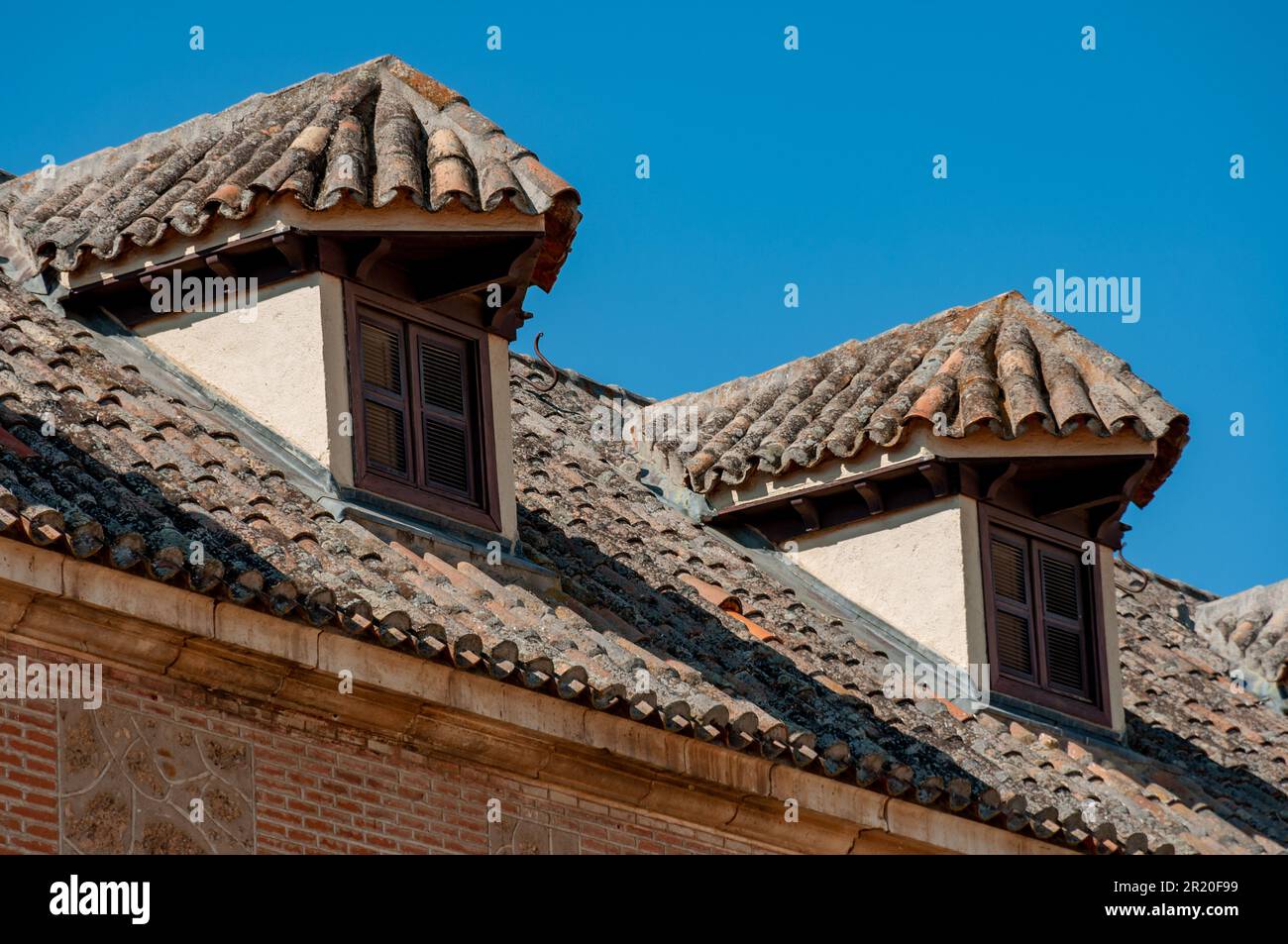 Spain. Aranjuez. Tiled roof with two windows and wooden frames with ...