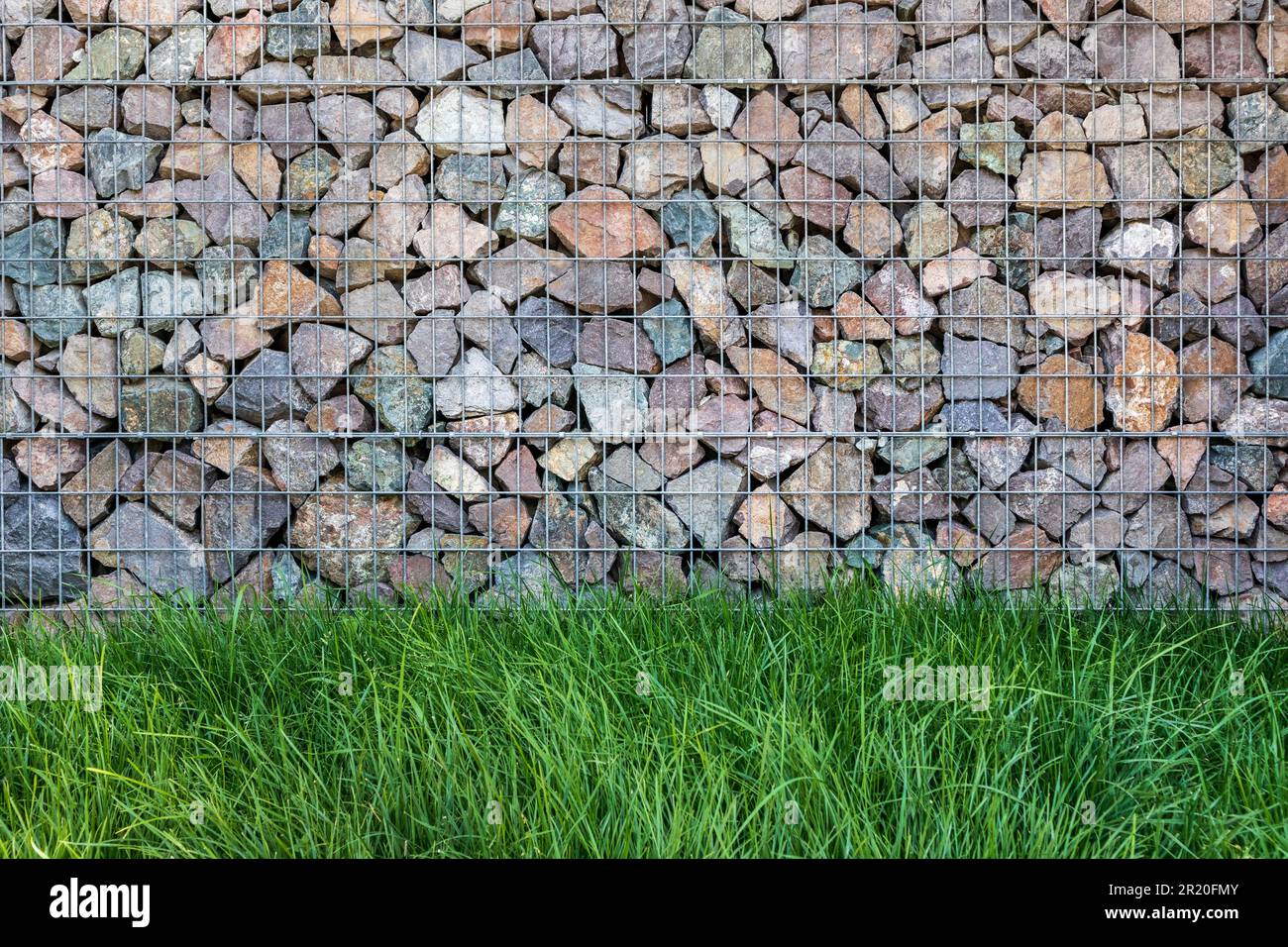 Wall of gabions and fluffy lawn grass in front of it, copy space Stock ...