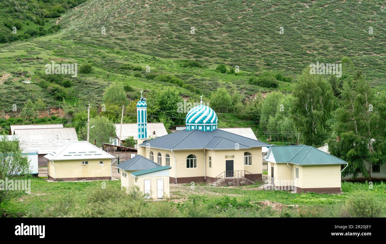Landscape in Kyrgyzstan with a local mosque which reflect the country's ...