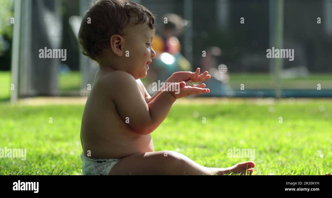 Beautiful baby toddler infant child outside in grass Stock Photo - Alamy