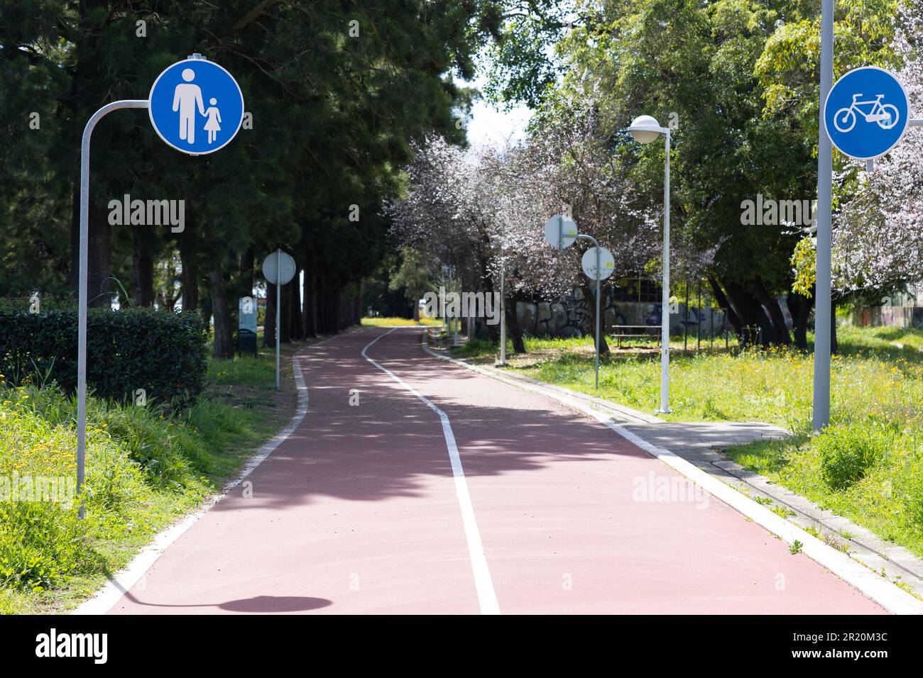 A path in the park - signs indicating the path for a bicycle and a ...