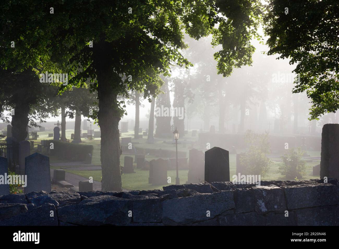 A moody, misty graveyard an early September morning Stock Photo - Alamy