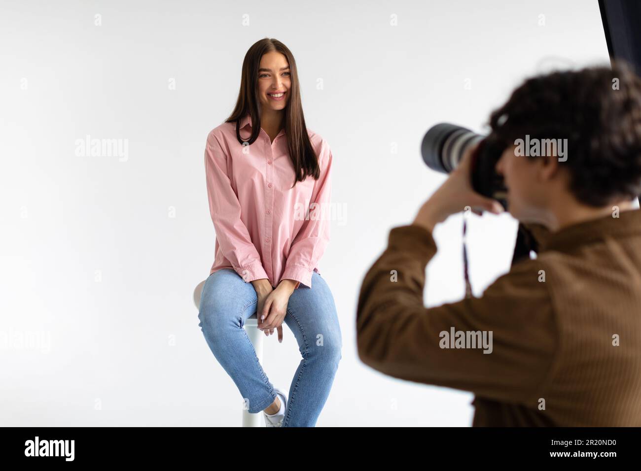 Creating captivating portraits. Photographer taking photos of young ...