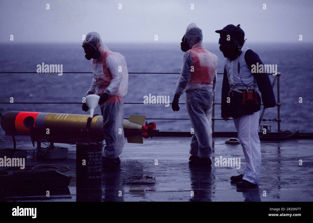 HMS Invincible crew prepare torpedo missiles on deck, 1984 Stock Photo ...