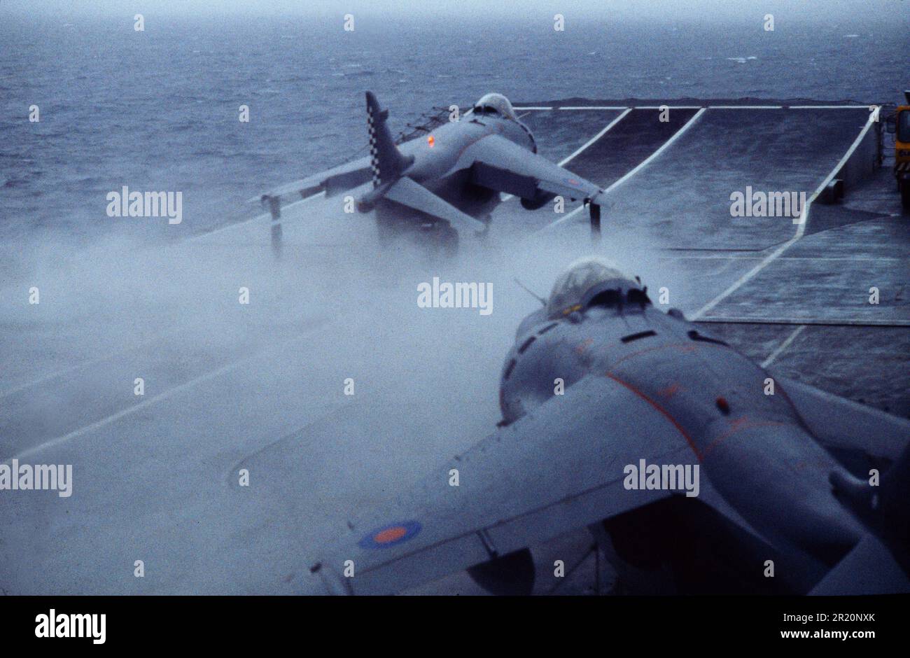 Harrier Jump Jet aircraft taking off from deck of the HMS Invincible in ...