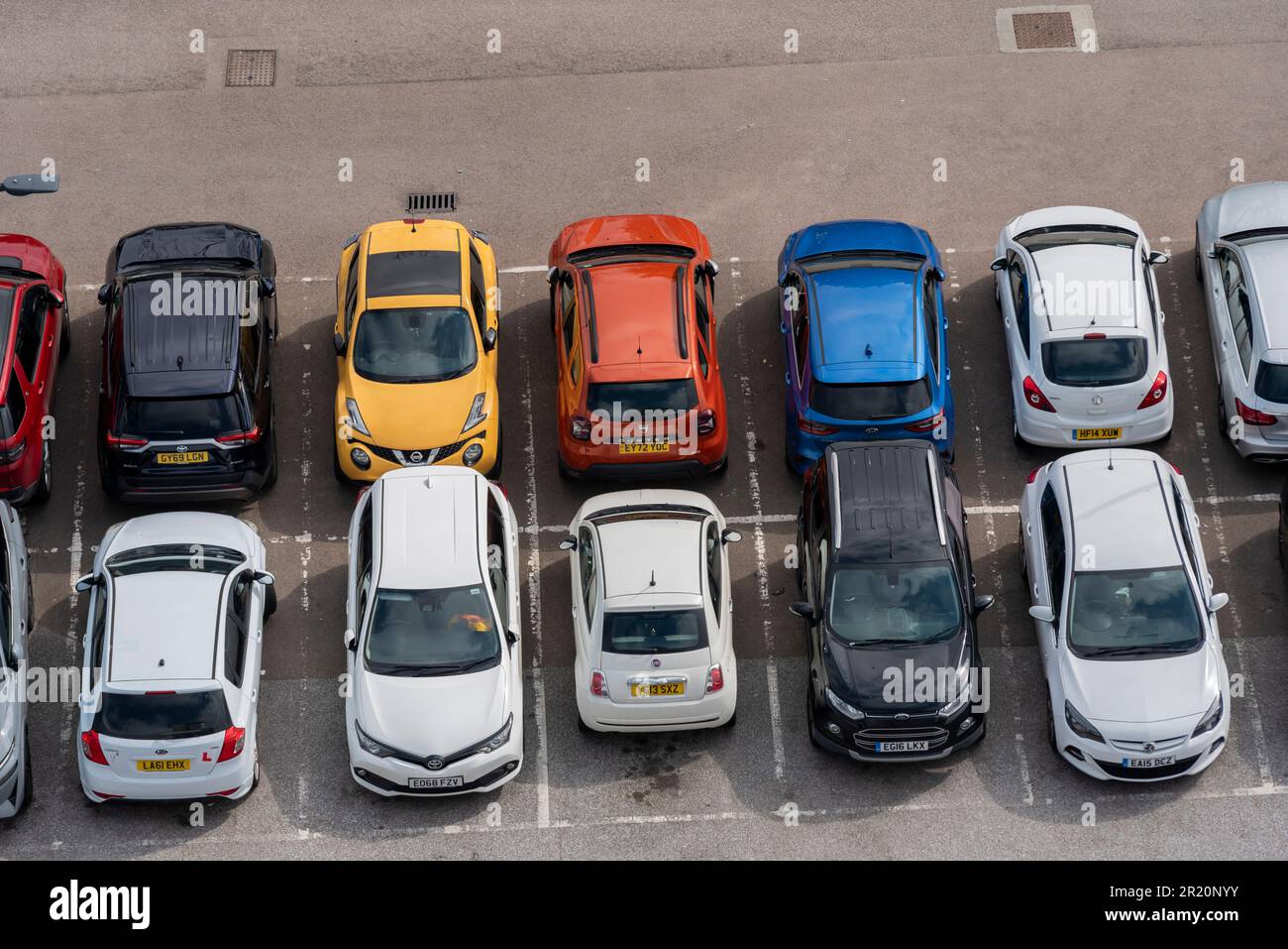 Cars parked in a car park, viewed from above. Marked out parking bays ...