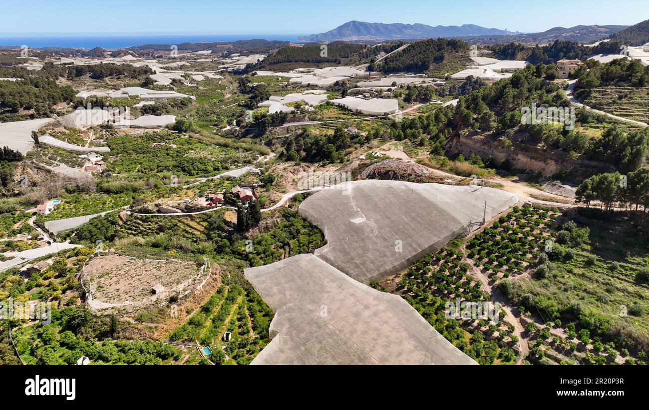 Mountains with cultivated ‘vineyards’ farmland and greenhouse ...