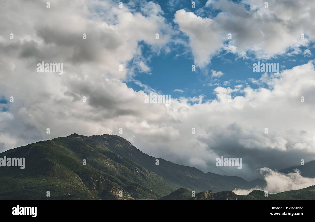 Mountains after the rain shrouded in clouds, the blue sky shines ...