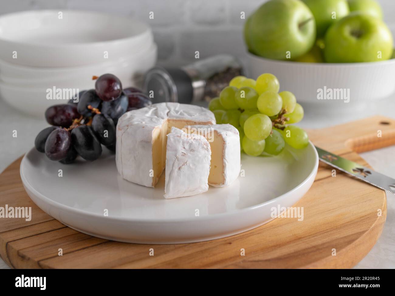 Brie or soft cheese, with dark and green grapes on a plate Stock Photo ...