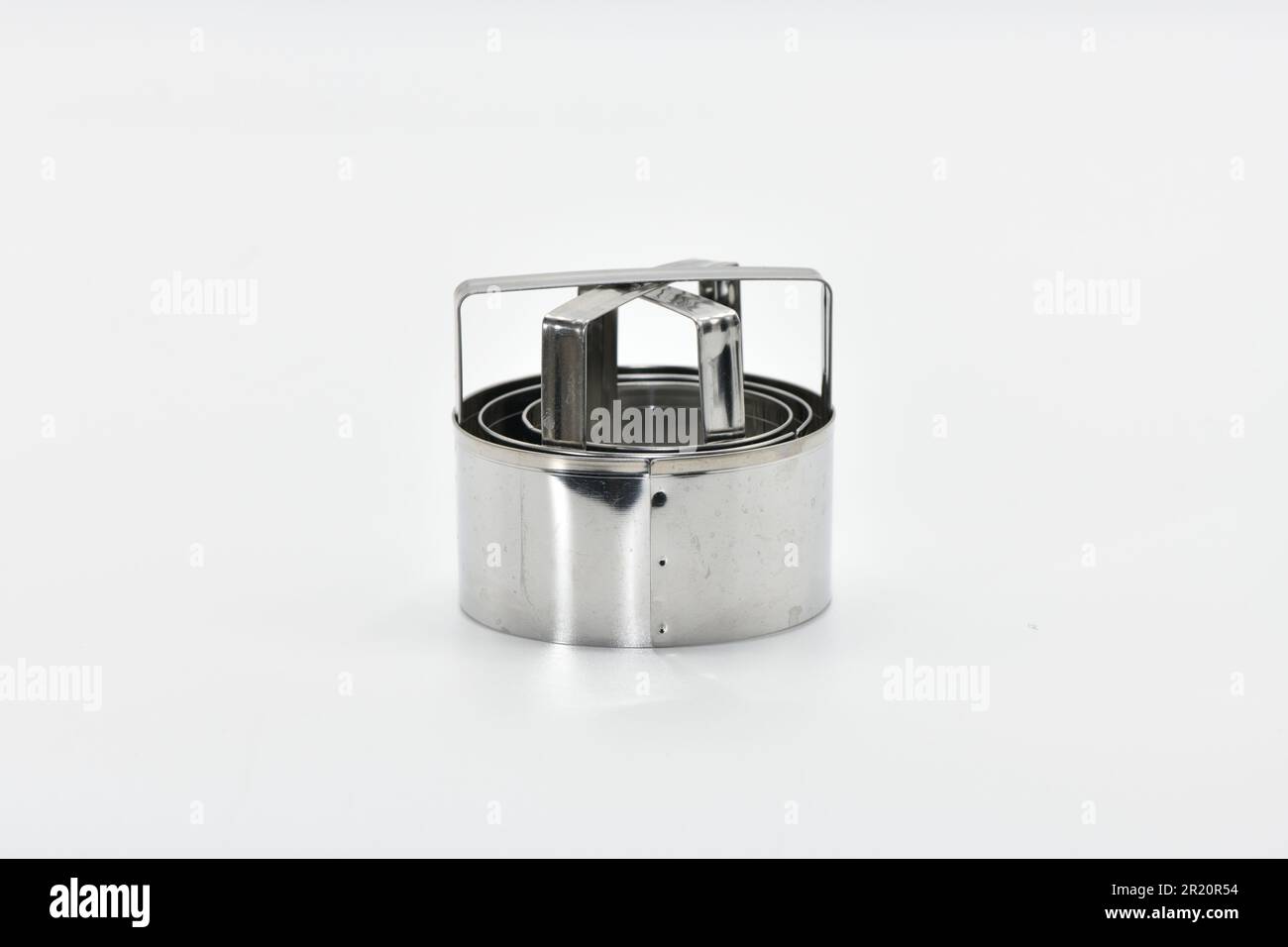 Stainless steel biscuit cutters on a white background Stock Photo - Alamy