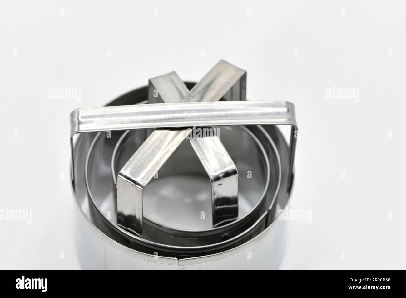 Stainless steel biscuit cutters on a white background Stock Photo - Alamy