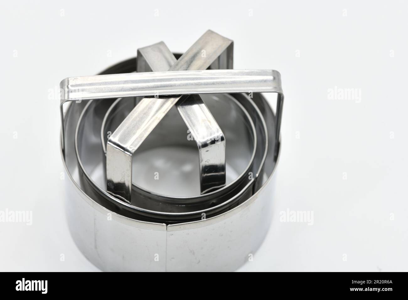 Stainless steel biscuit cutters on a white background Stock Photo - Alamy