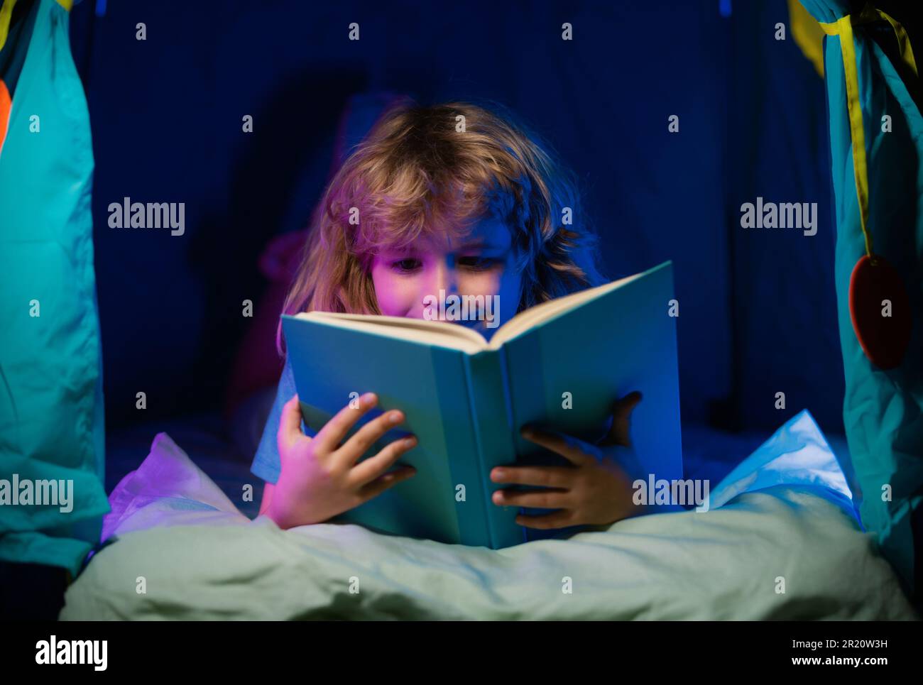 Child boy reading book. Little boy sitting on in living room watching ...