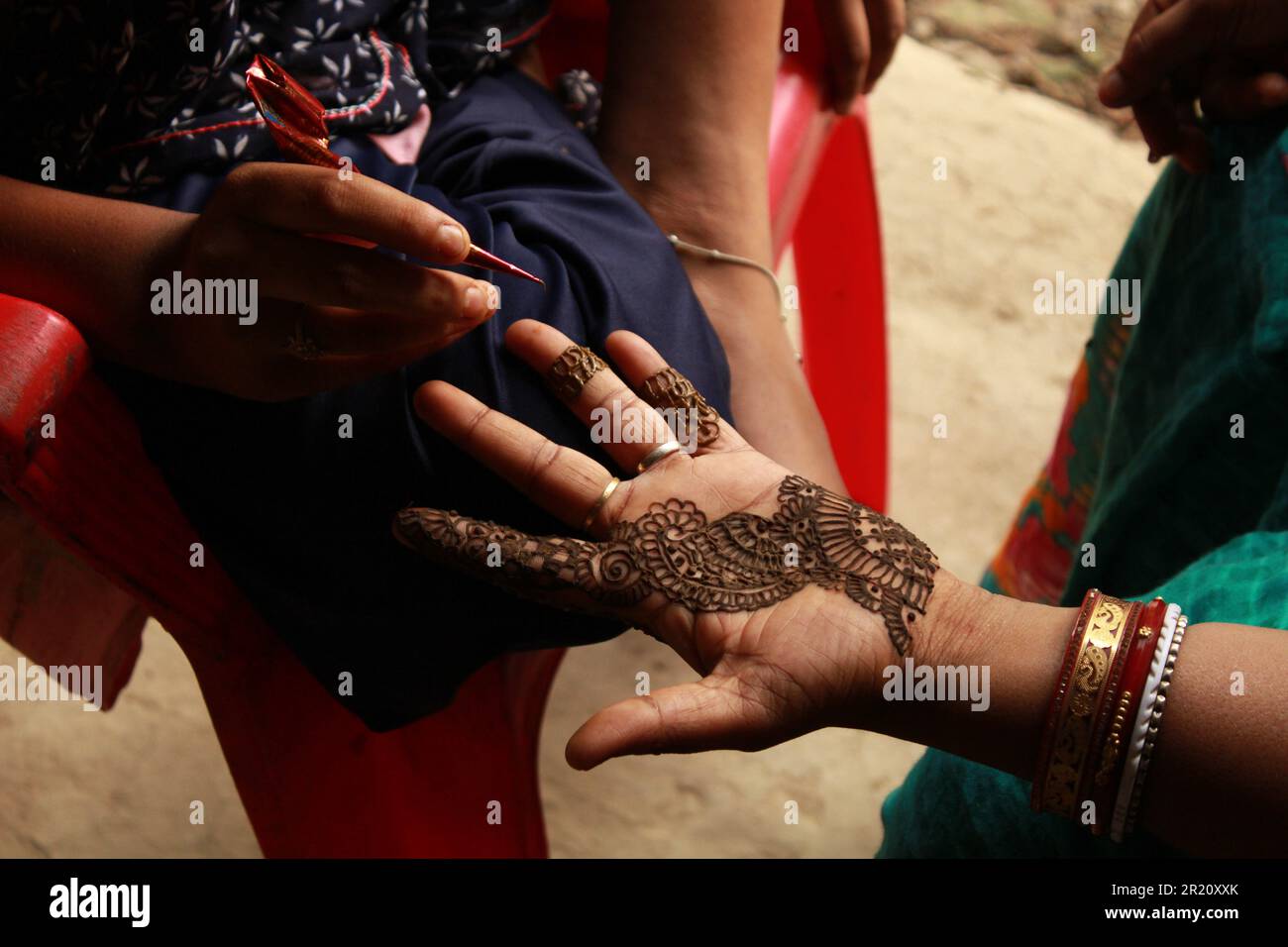 Indian Teenage Girl Applying Heena Tatoo On Woman's Hand Stock Photo ...