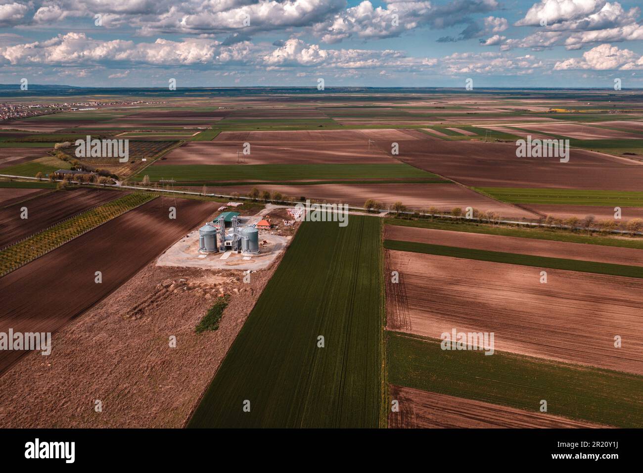 Aerial shot of grain silos in countryside landscape, drone pov ...