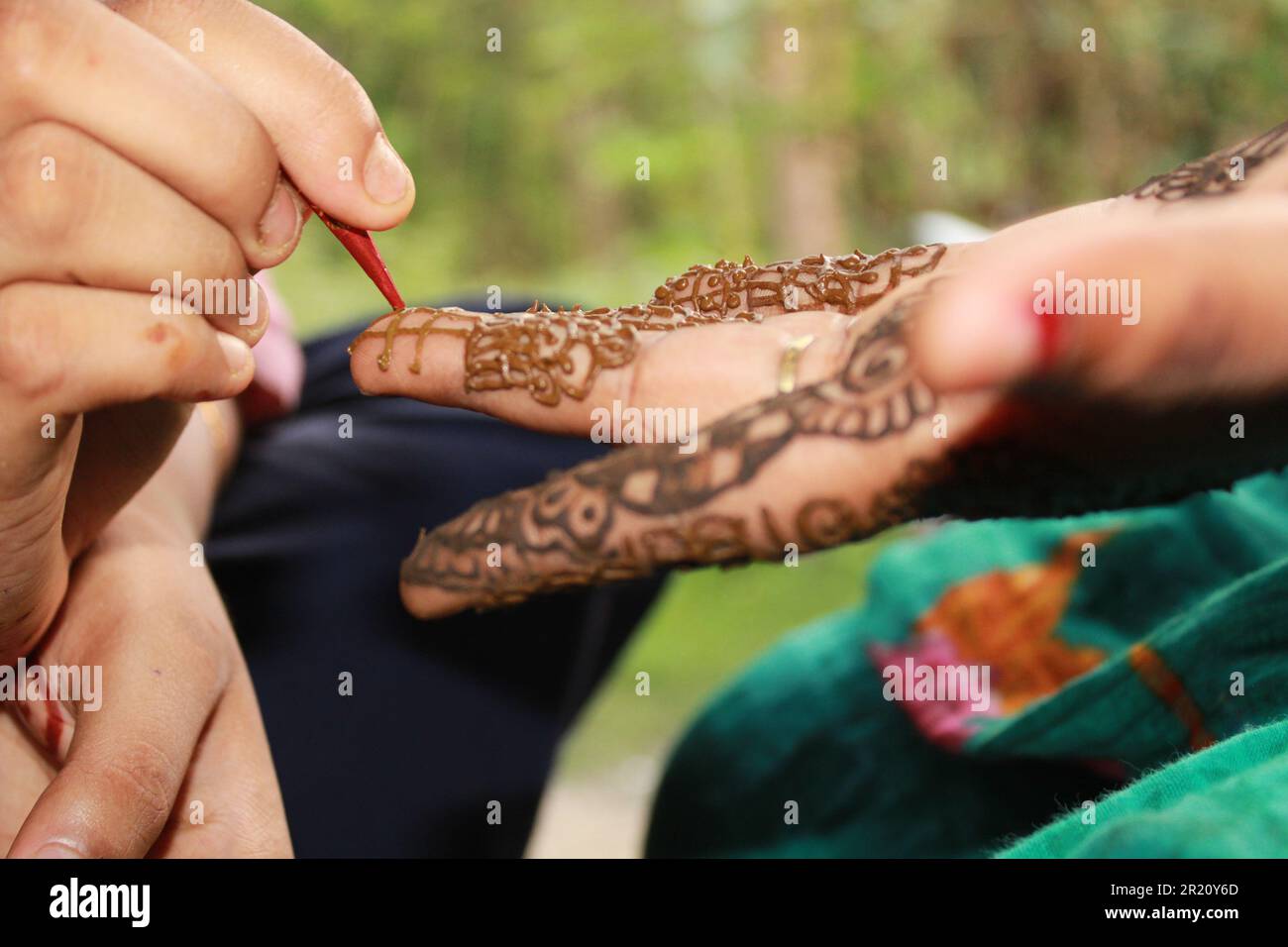 Young Teen Age Indian Girl painting henna Tattoo on the hand Stock ...