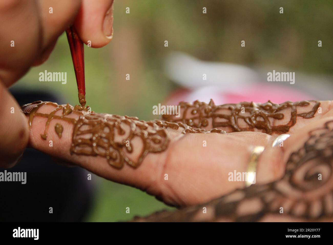 Indian Teenage Girl Applying Heena Tatoo On Woman's Hand Stock Photo ...