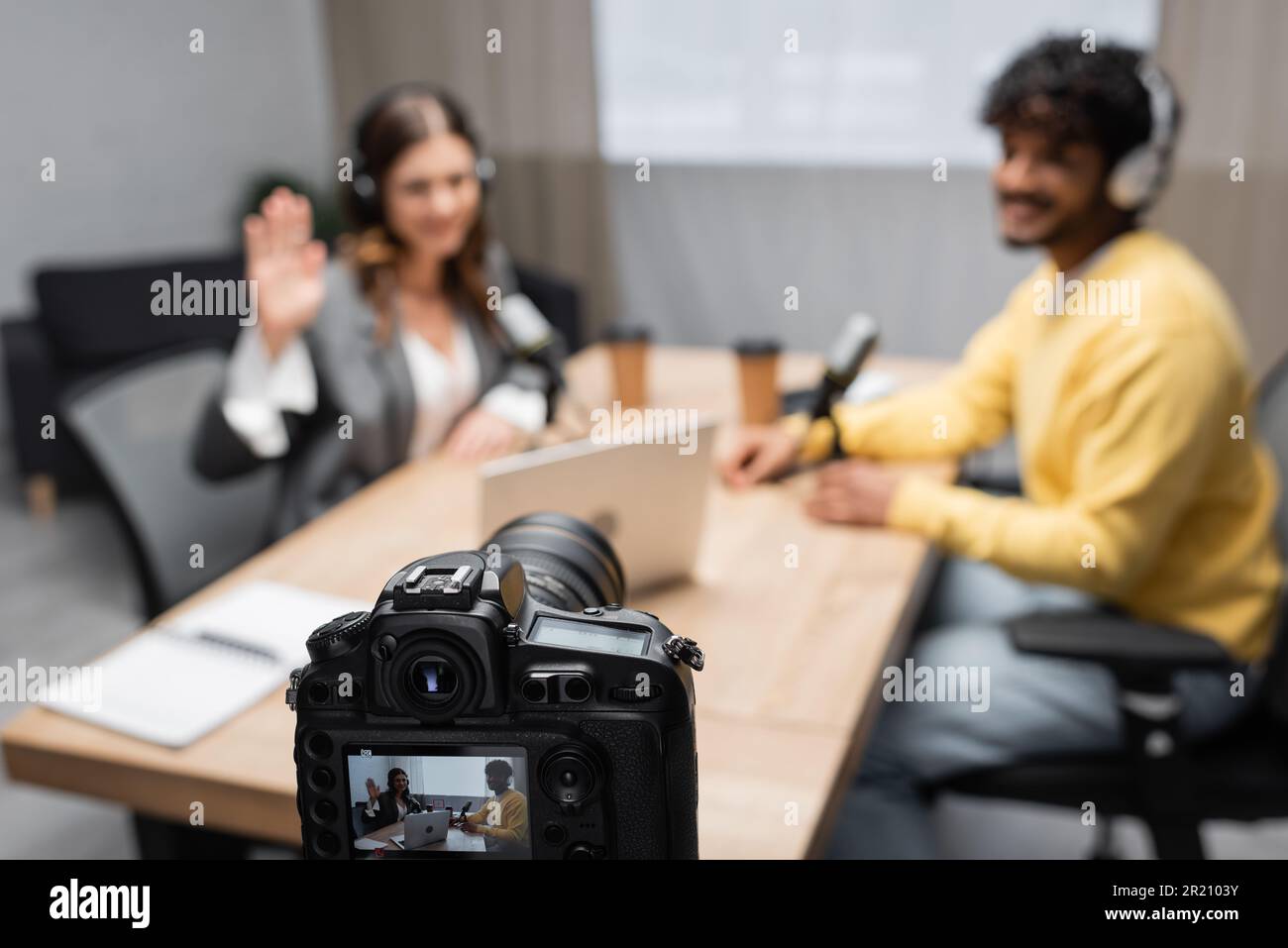 professional digital camera recording interview of woman waving hand ...
