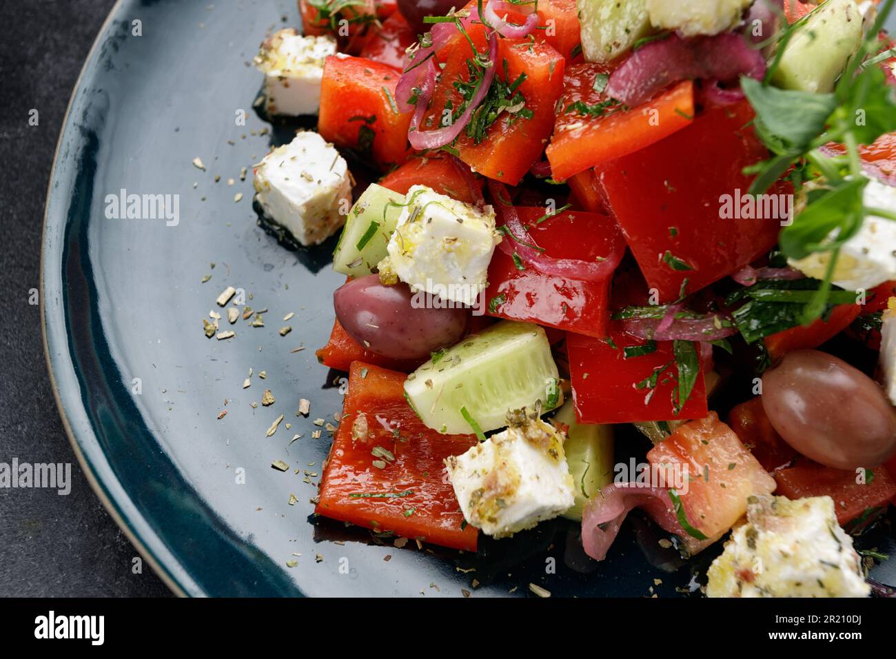 beautifully presented Greek salad in close-up, against dark background ...