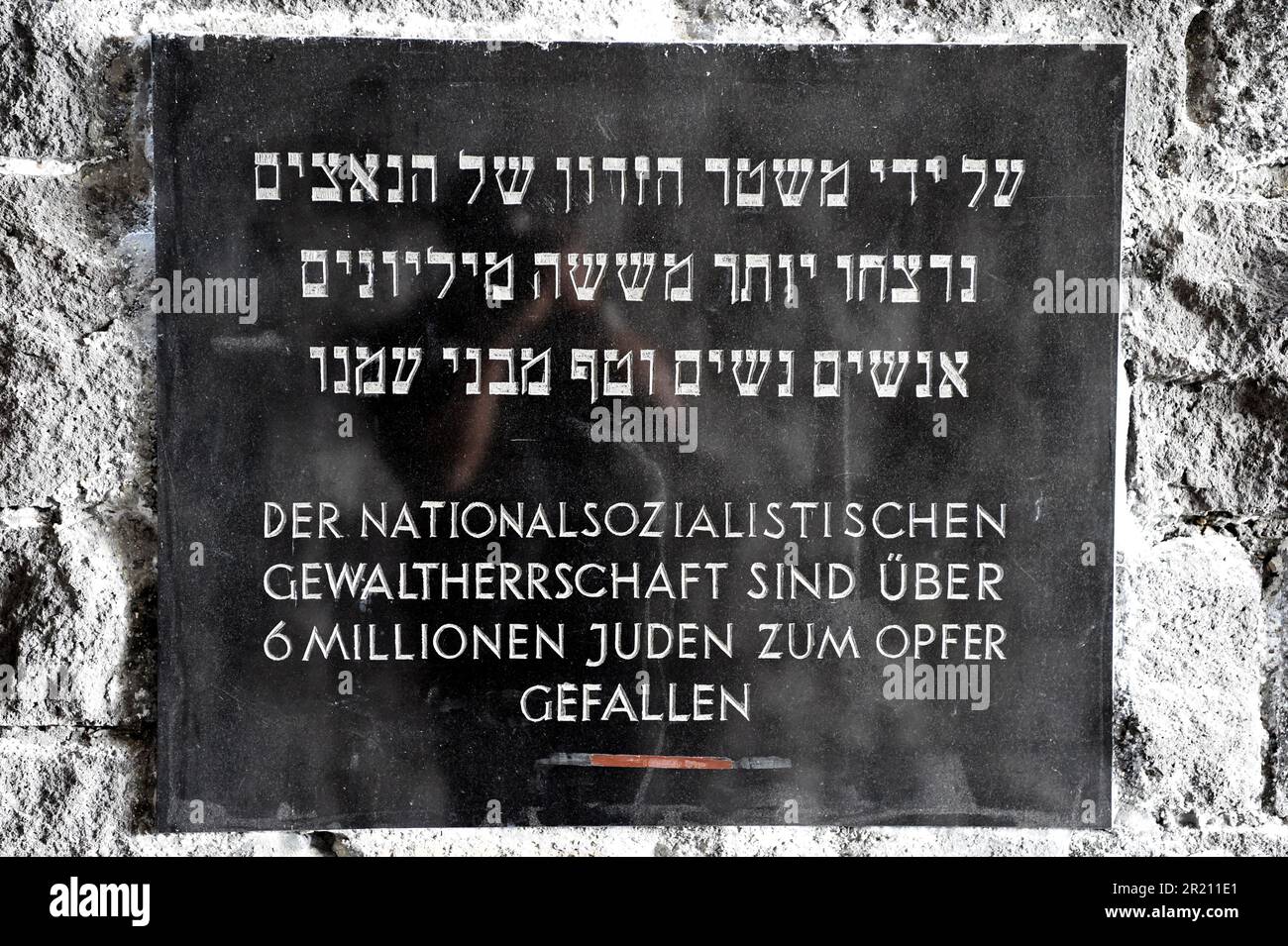 Photograph of a memorial plaque at Dachau concentration camp. It is ...