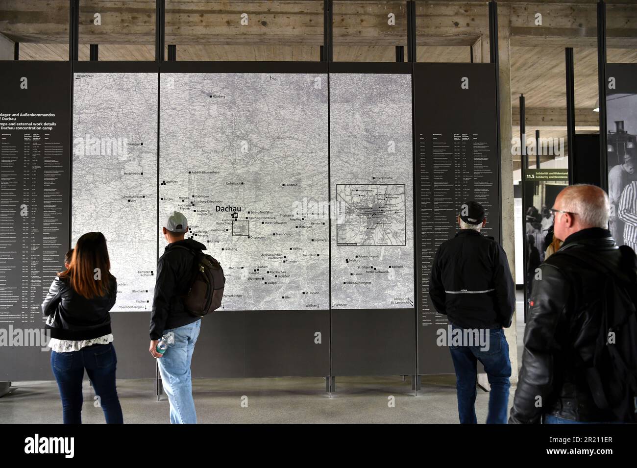 Photograph of tourists looking at a map at Dachau concentration camp ...