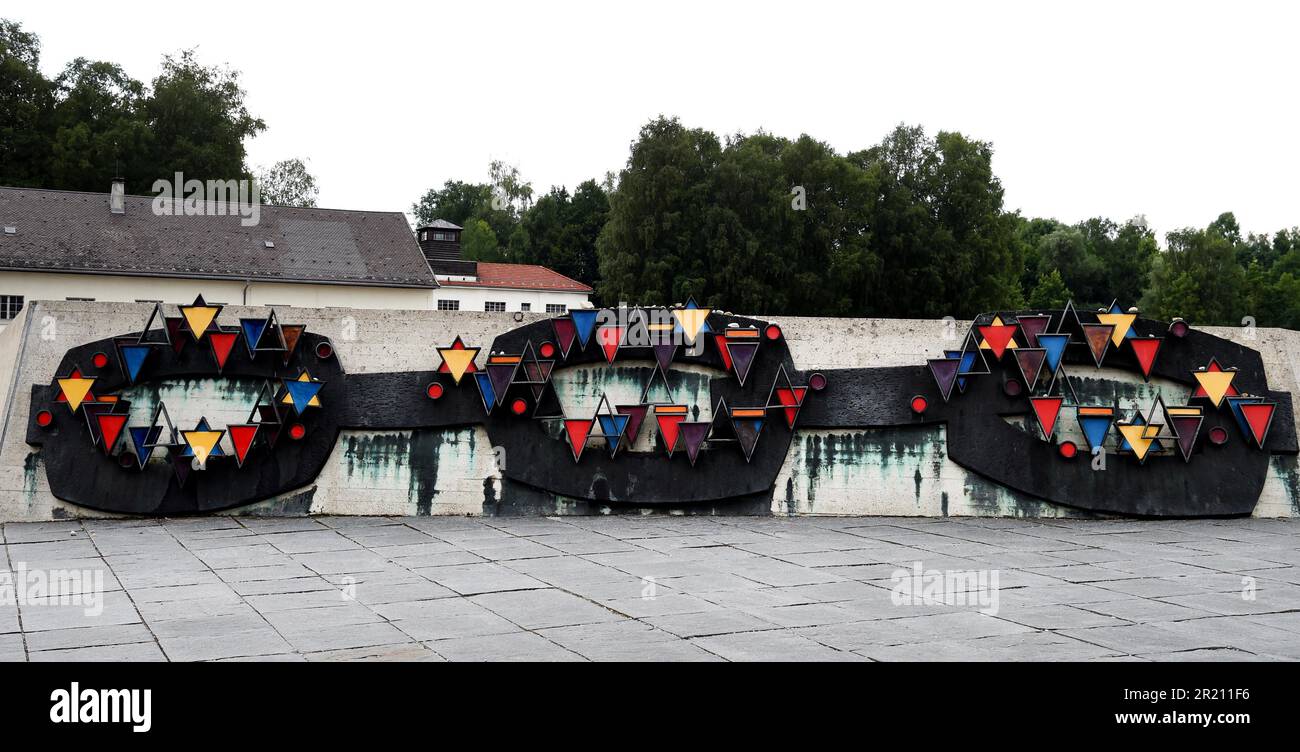 Photograph a memorial sculpture at Dachau concentration camp. The ...