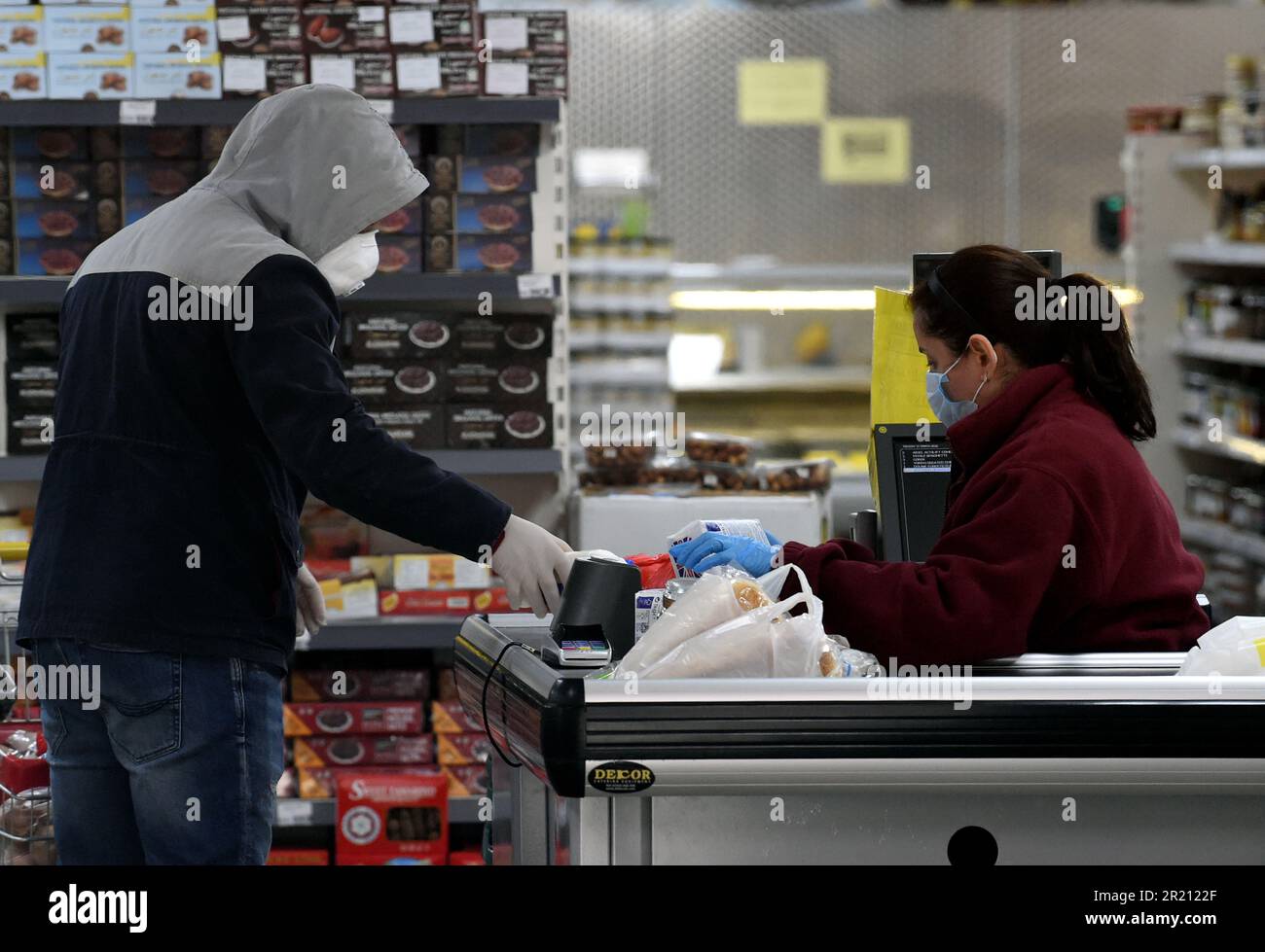Photograph of a shopper and worker wearing face coverings during the ...