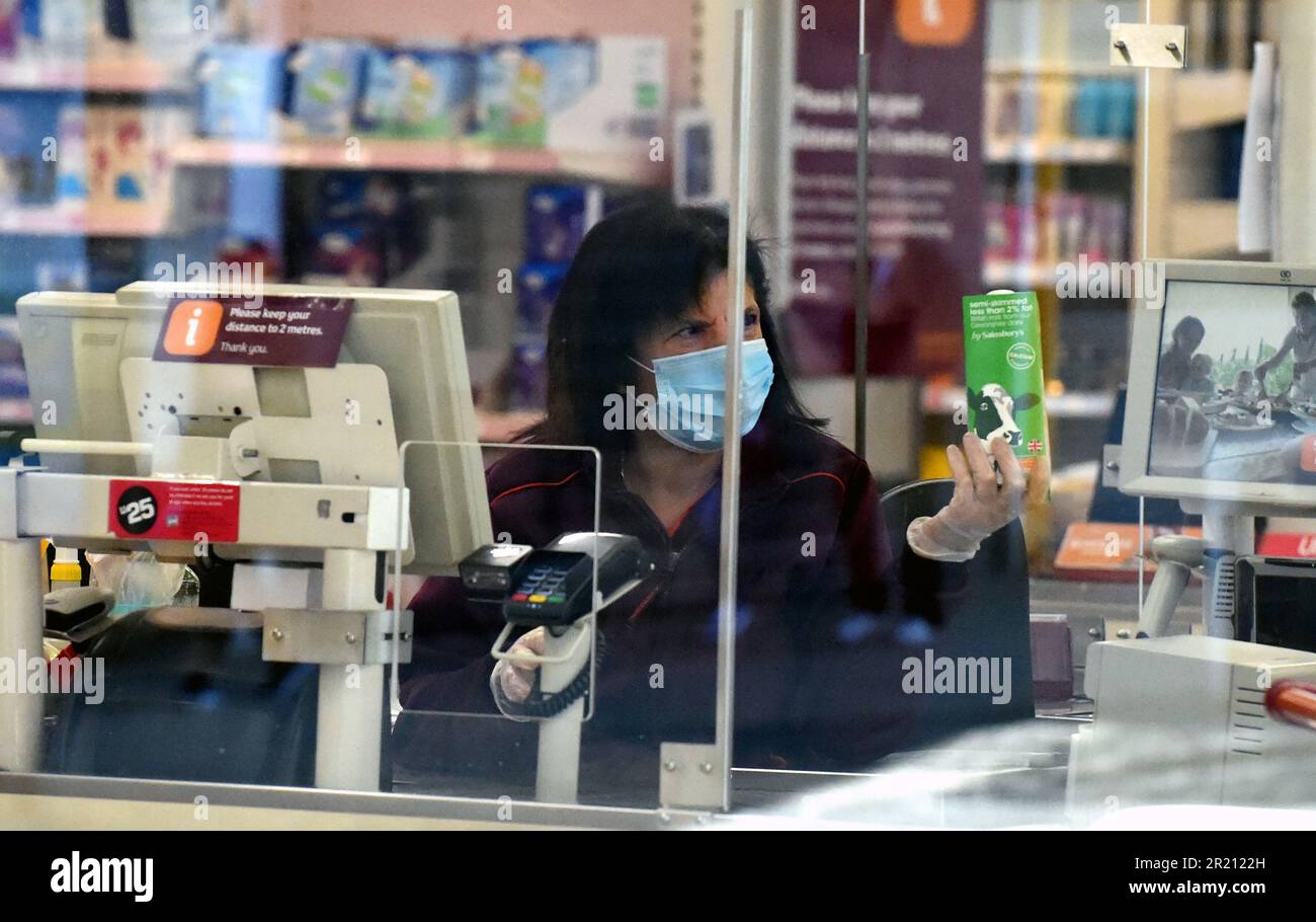 Photograph of a Sainsbury's worker wearing a face covering during the ...