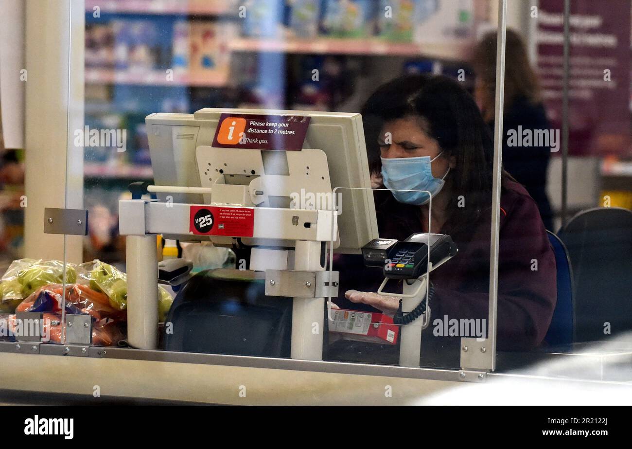 Photograph of a Sainsbury's worker wearing a face covering during the ...