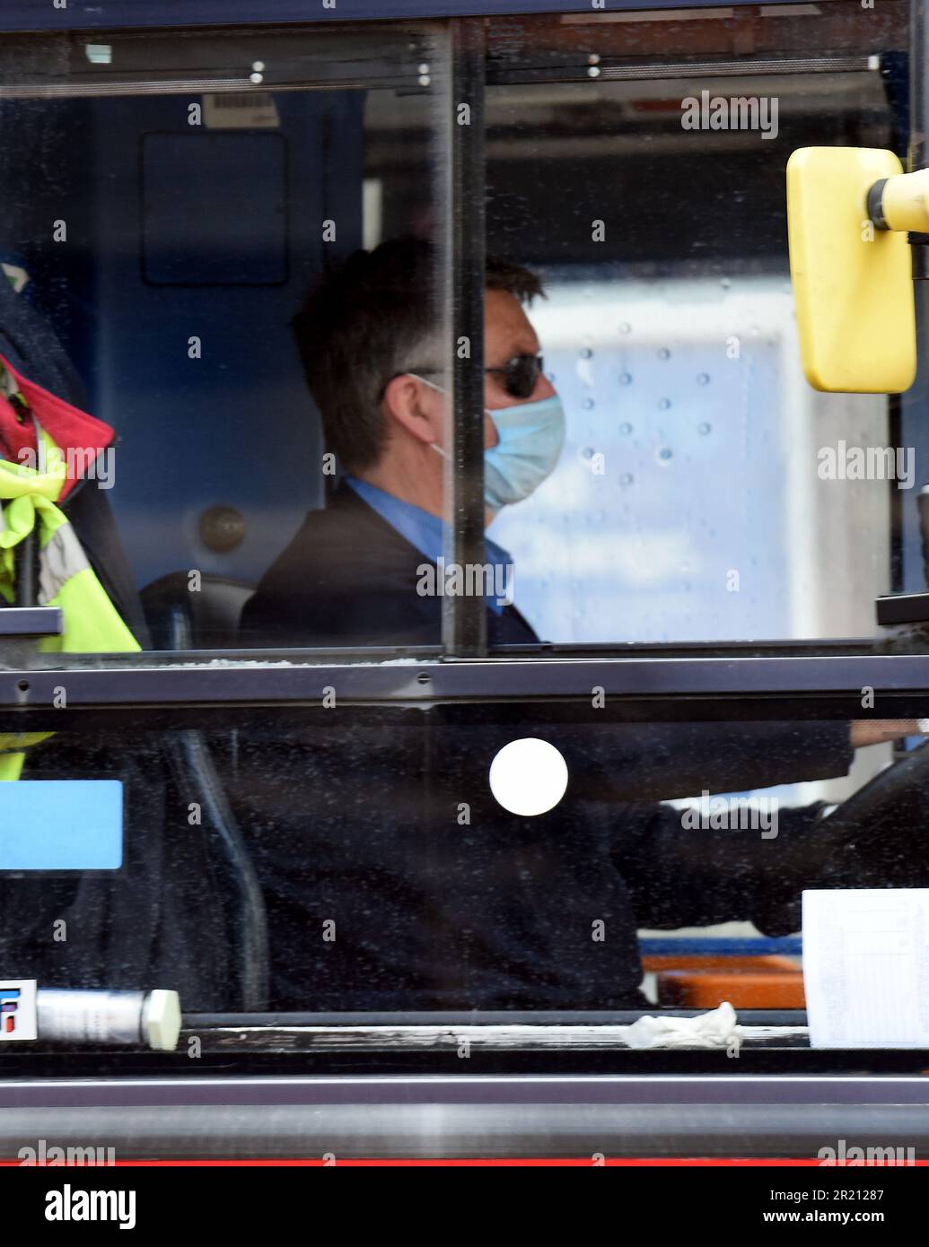 Photograph of a London bus driver during the Covid-19 pandemic. He is ...