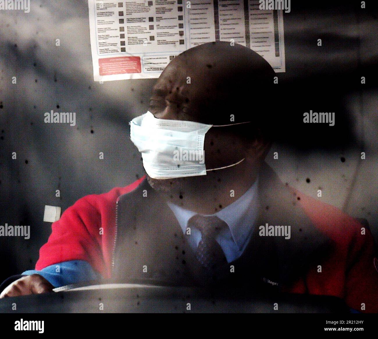 Photograph of a London bus driver during the Covid-19 pandemic. He is ...