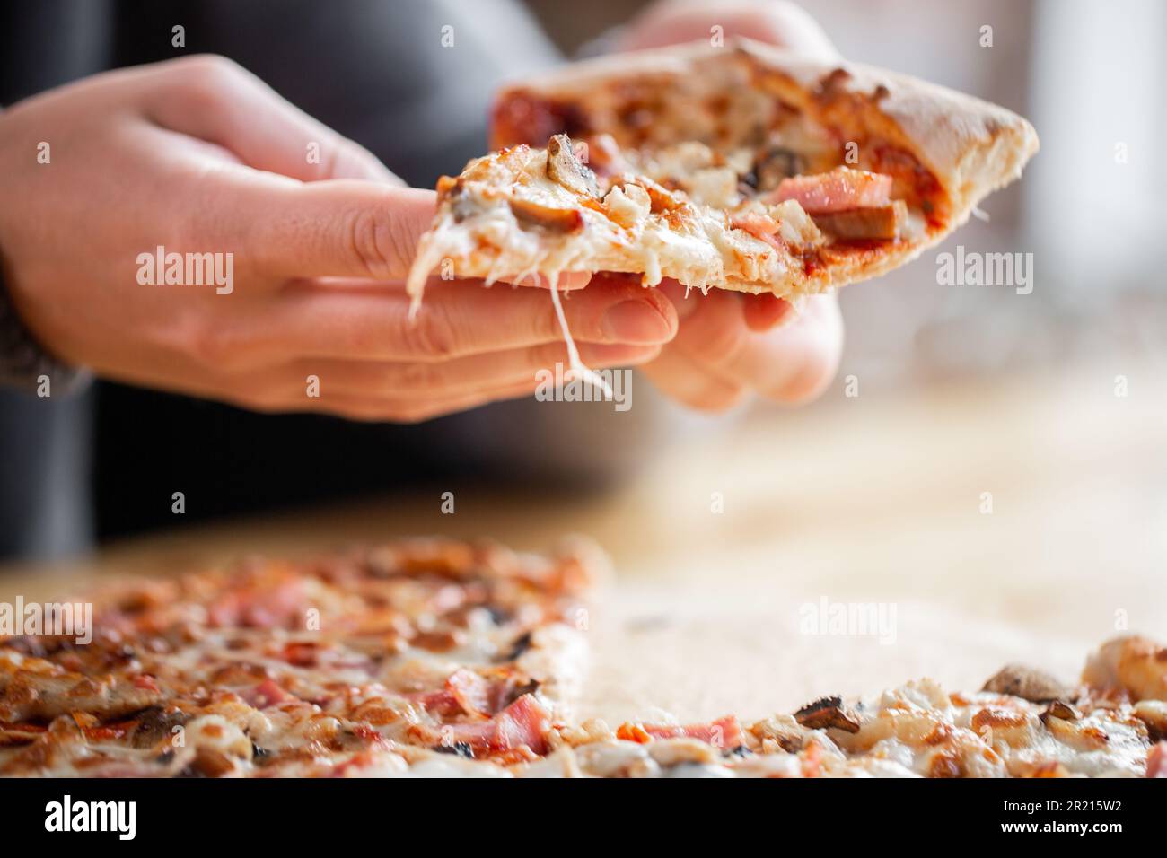 one people taking slices of pizza out of the box. fast delivery of food ...