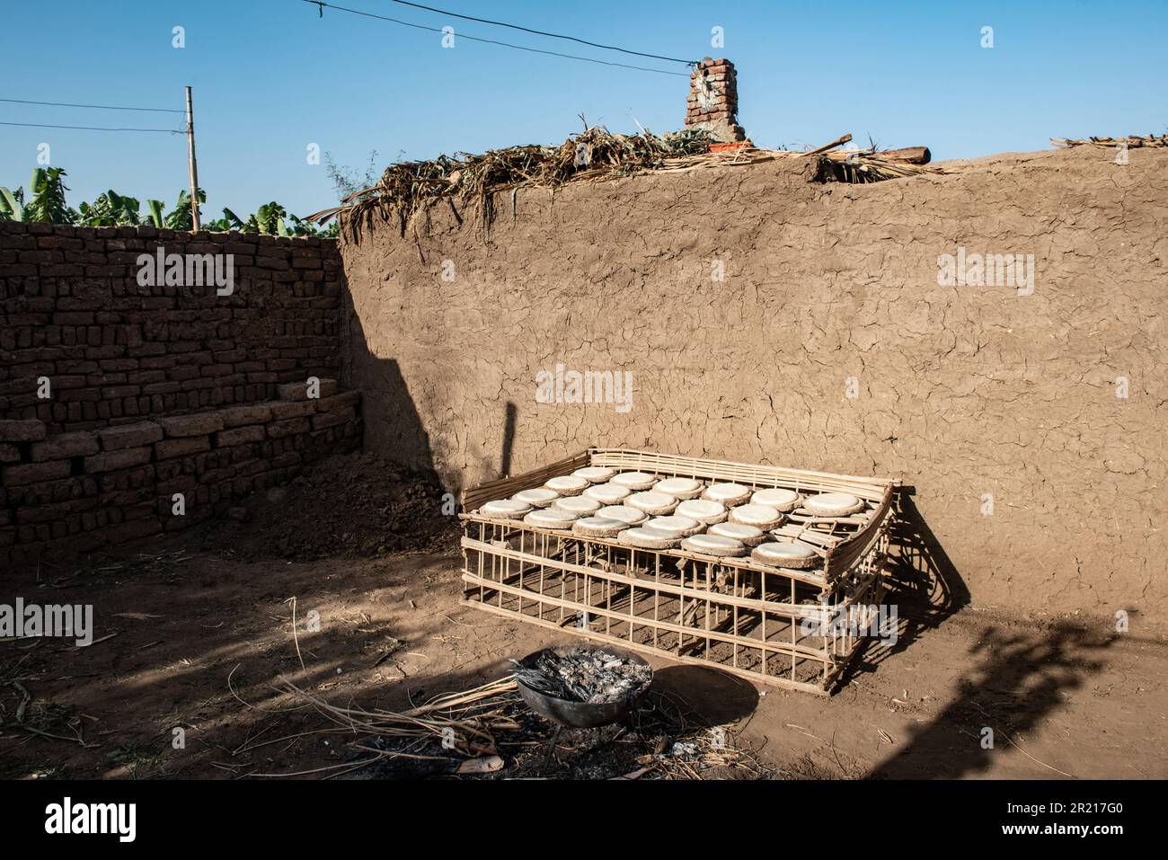 Freshly made dough to make traditional bread drying in the sun outside ...