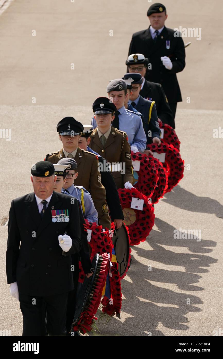 Military personnel hold wreaths on the Armed Forces Memorial during ...