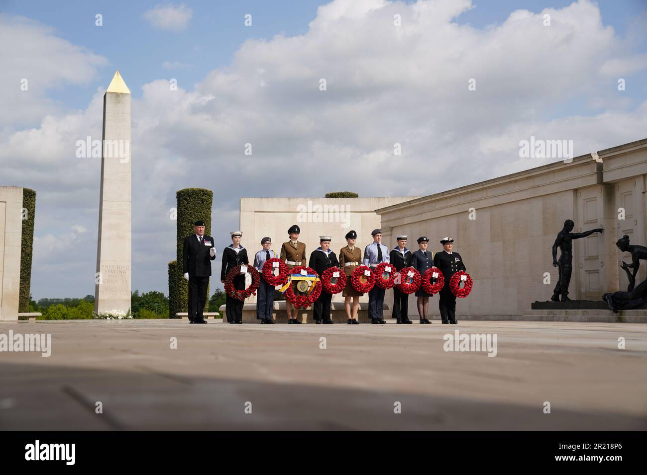 Military personnel hold wreaths on the Armed Forces Memorial during ...
