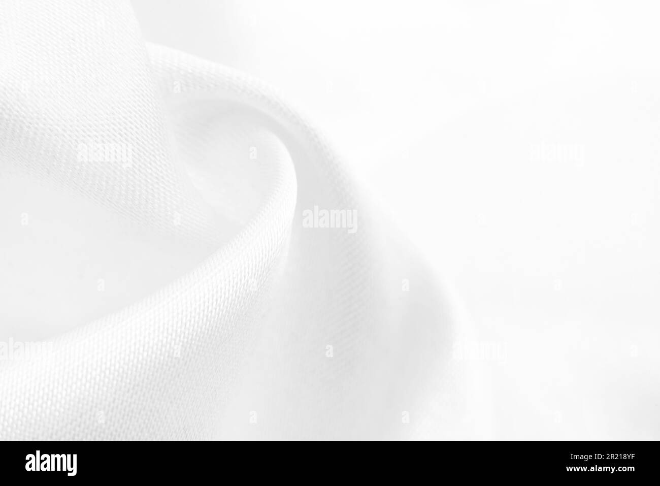 A twisted piece of white fabric. White material or texture with waves ...