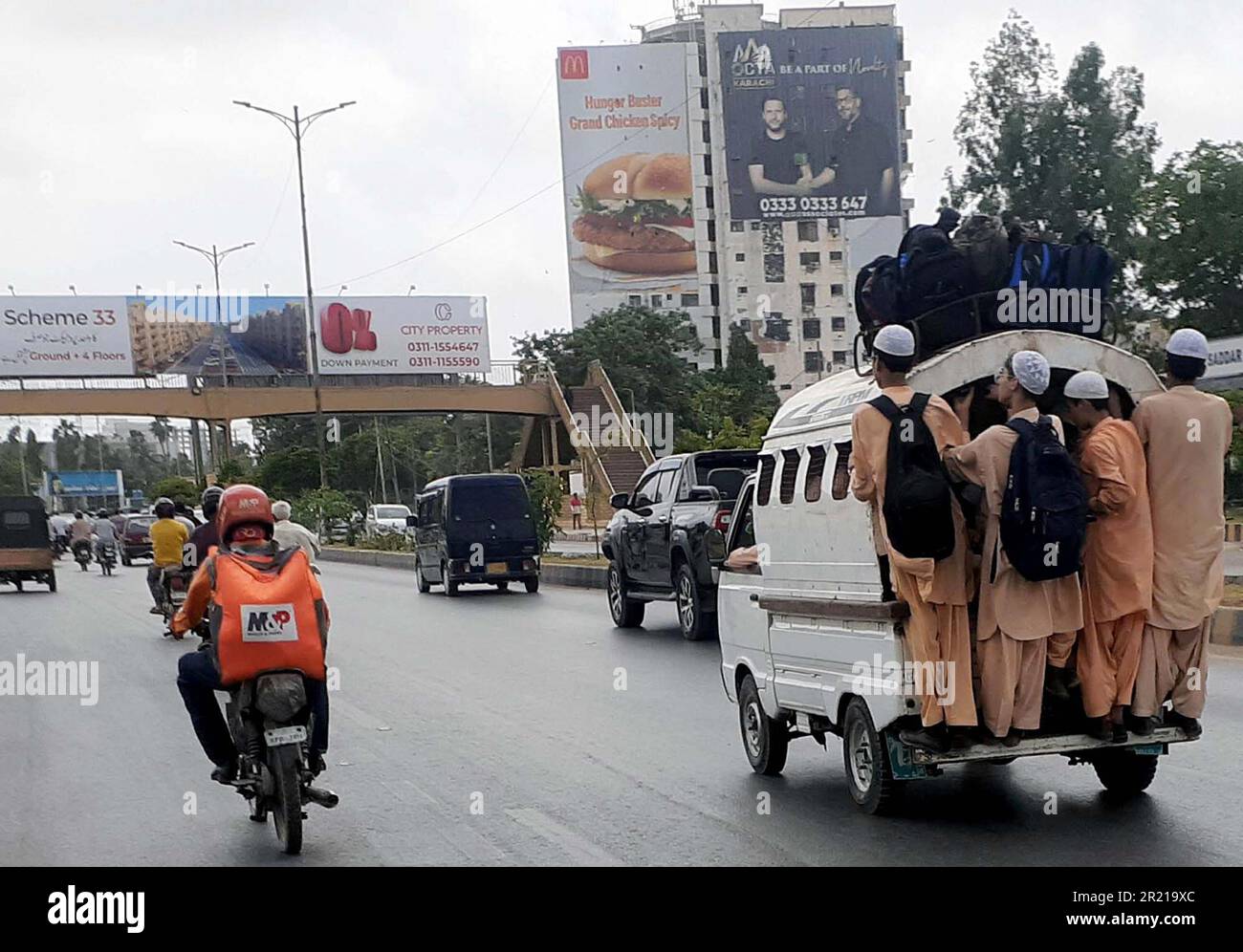 Karachi, Pakistan, May 16, 2023. Students are travelling dangerously on ...