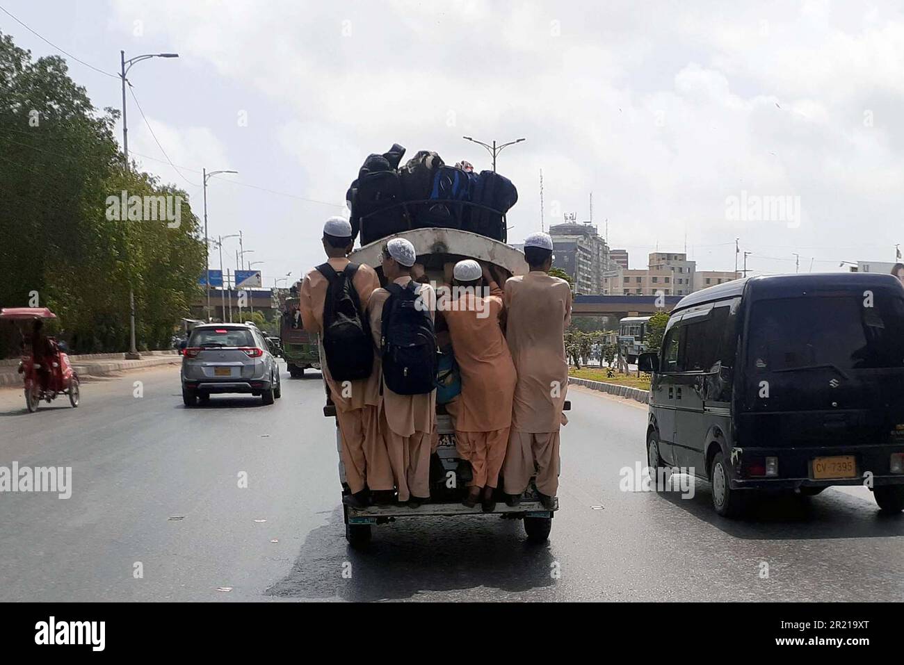 Karachi, Pakistan, May 16, 2023. Students are travelling dangerously on ...