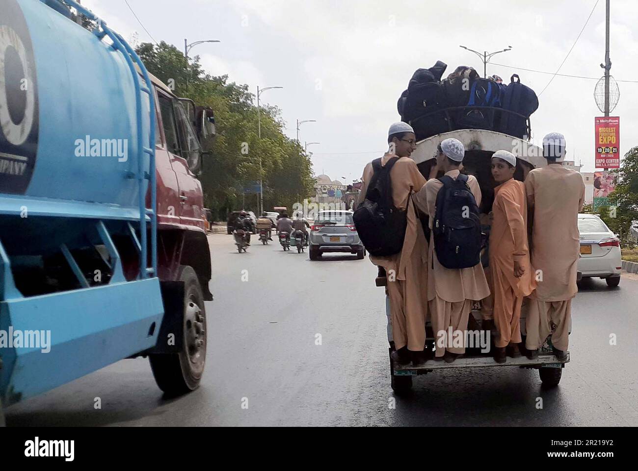 Karachi, Pakistan, May 16, 2023. Students are travelling dangerously on ...