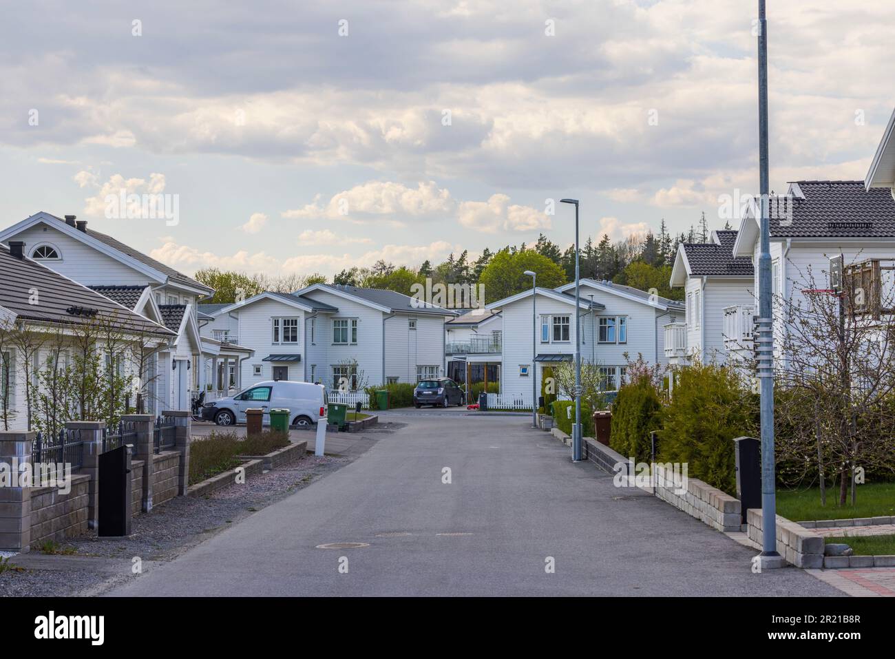 Beautiful view of modern European suburb with wooden white villas. New ...